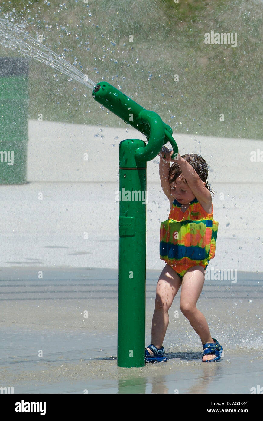 Small child plays with a water gun at a water park Stock Photo - Alamy