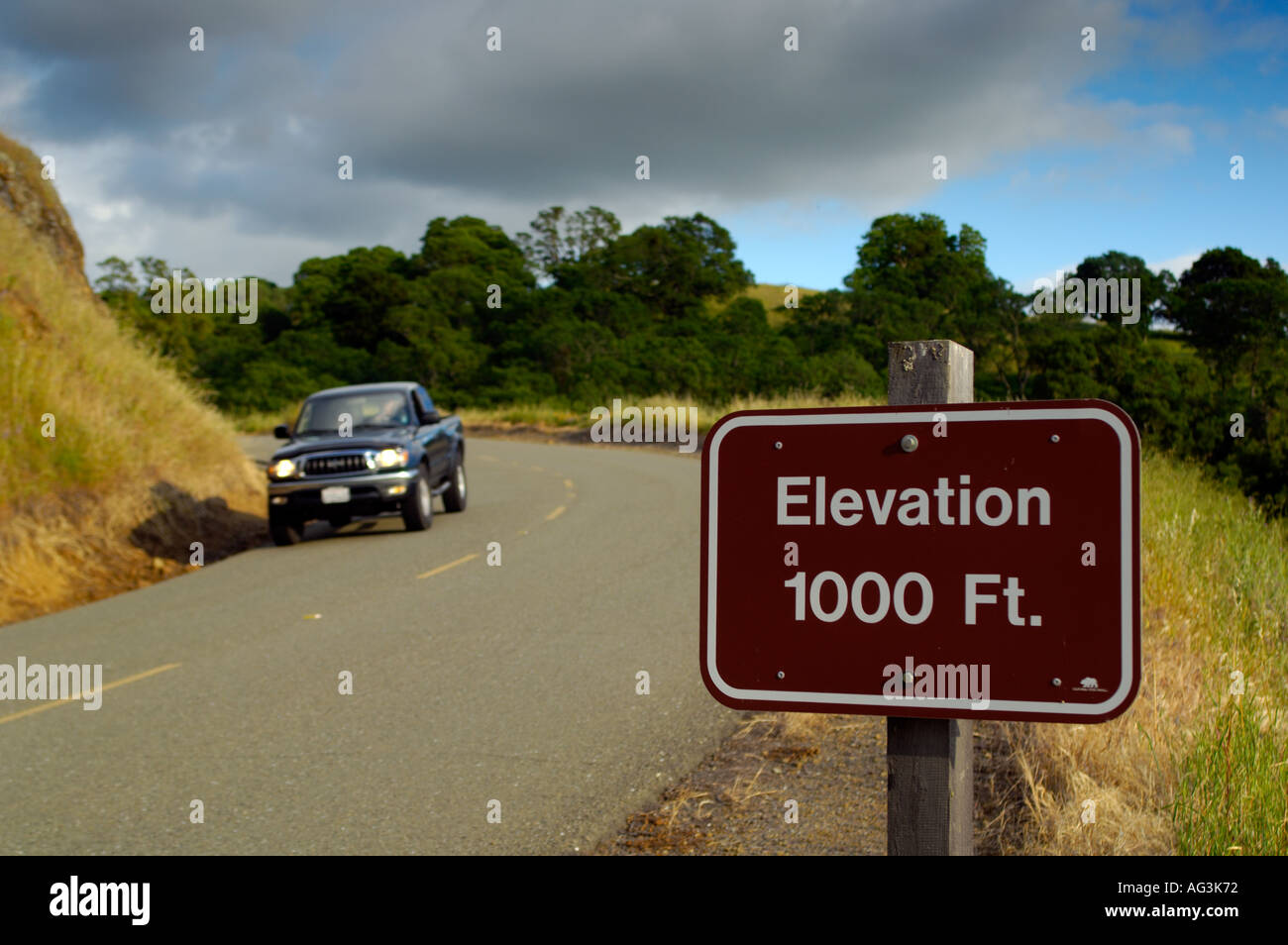 Pick up truck going downhill on road past elevation marker sign Mount ...
