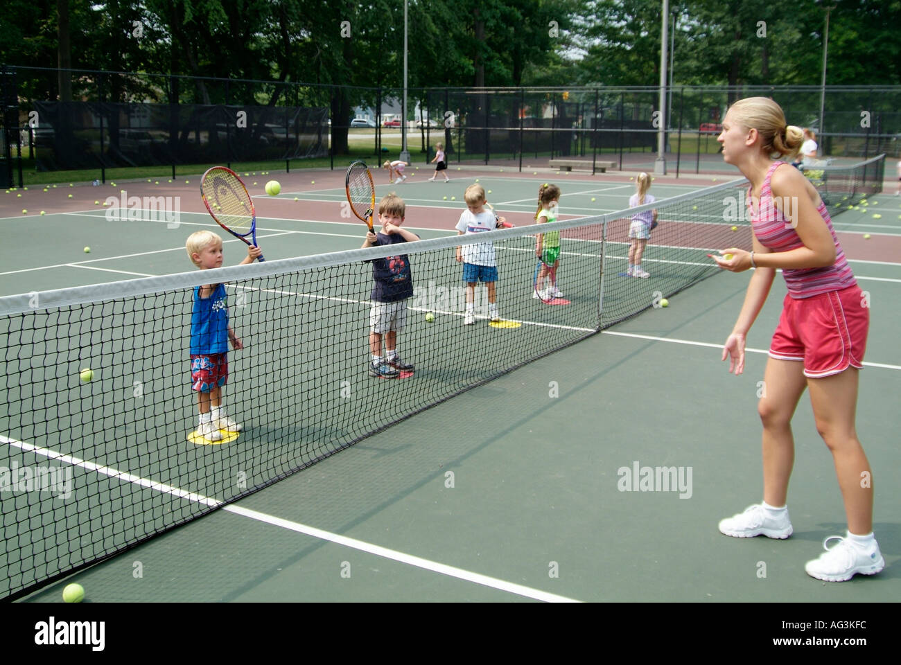 4 and 5 year old children take group tennis lessons taught by college ...