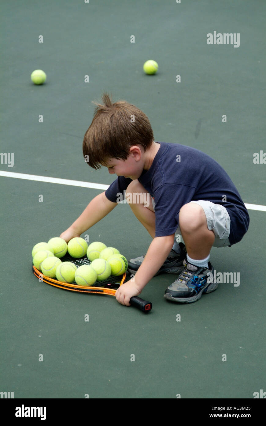 4 and 5 year old children take group tennis lessons taught by college ...
