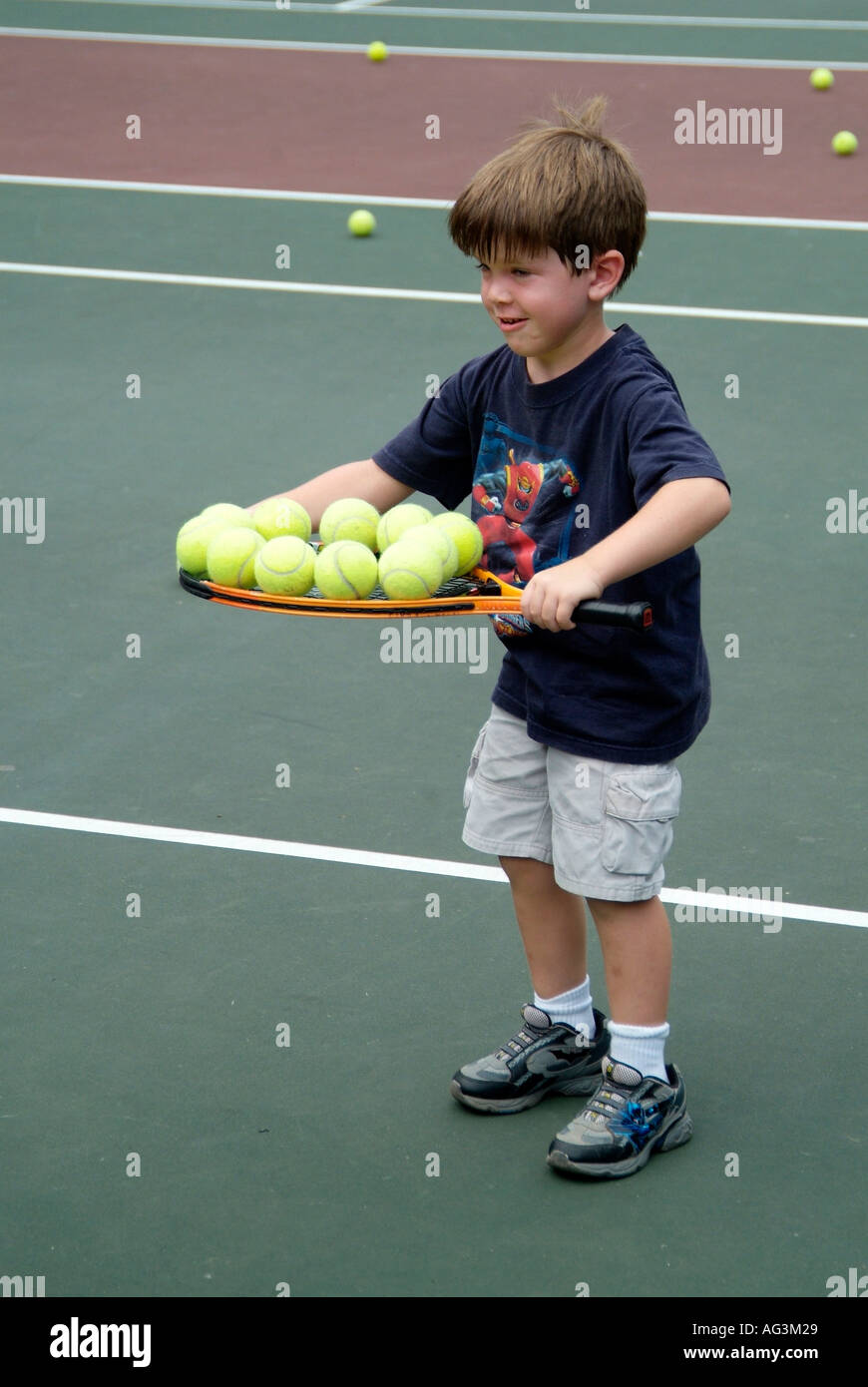 4 and 5 year old children take group tennis lessons taught by college ...