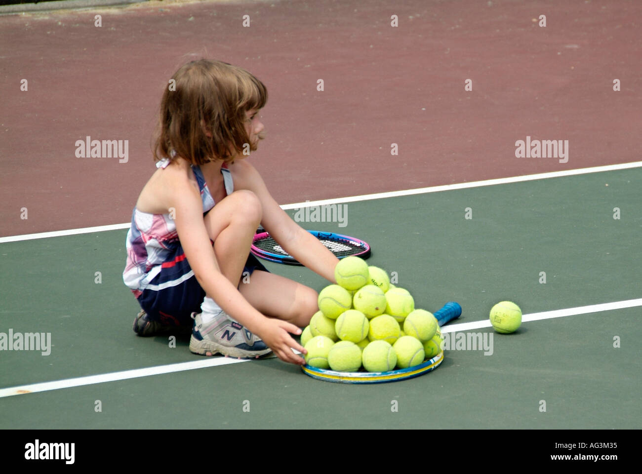 4 and 5 year old children take group tennis lessons taught by college ...