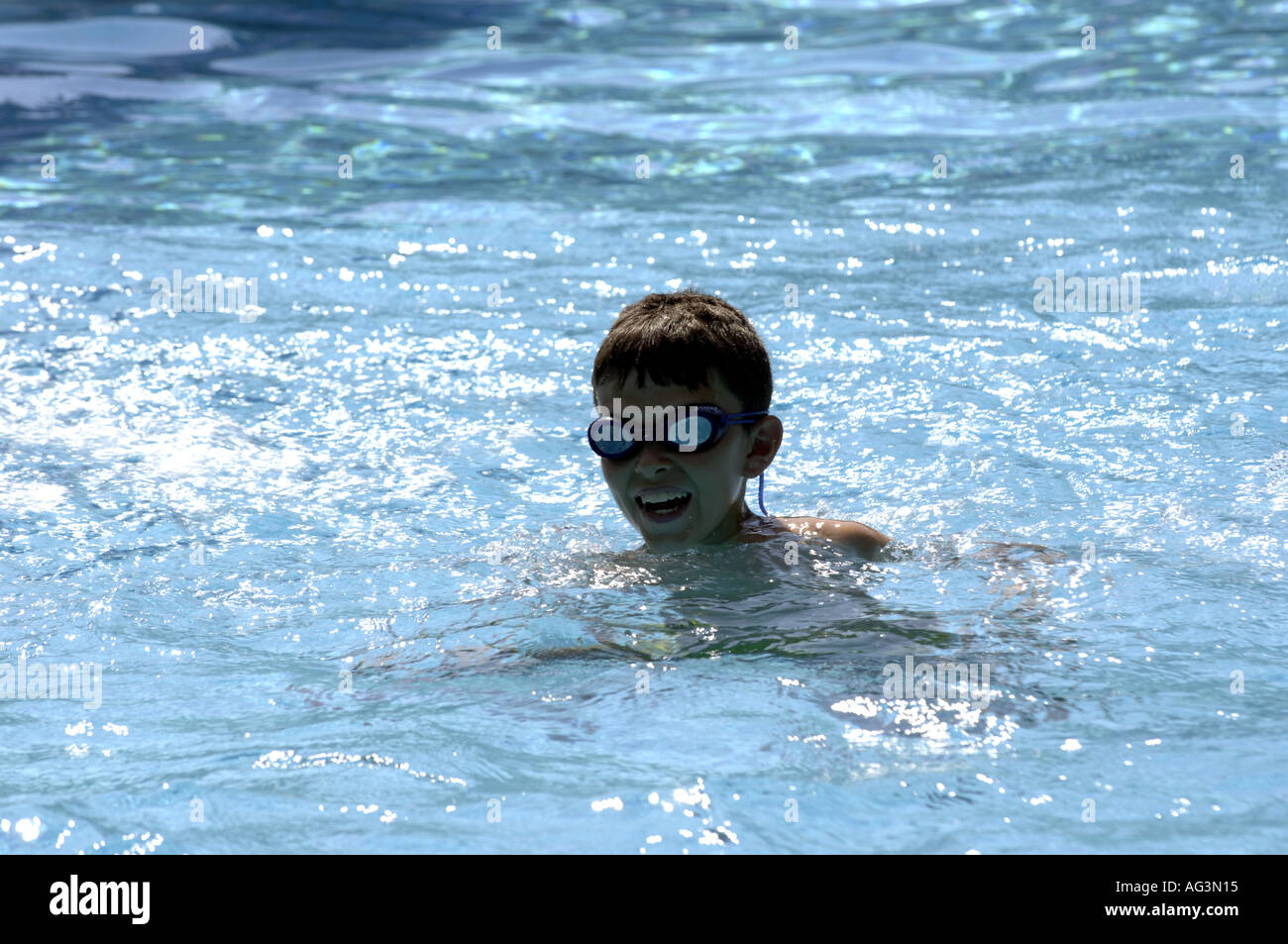 swimming pool boy with goggles Stock Photo - Alamy
