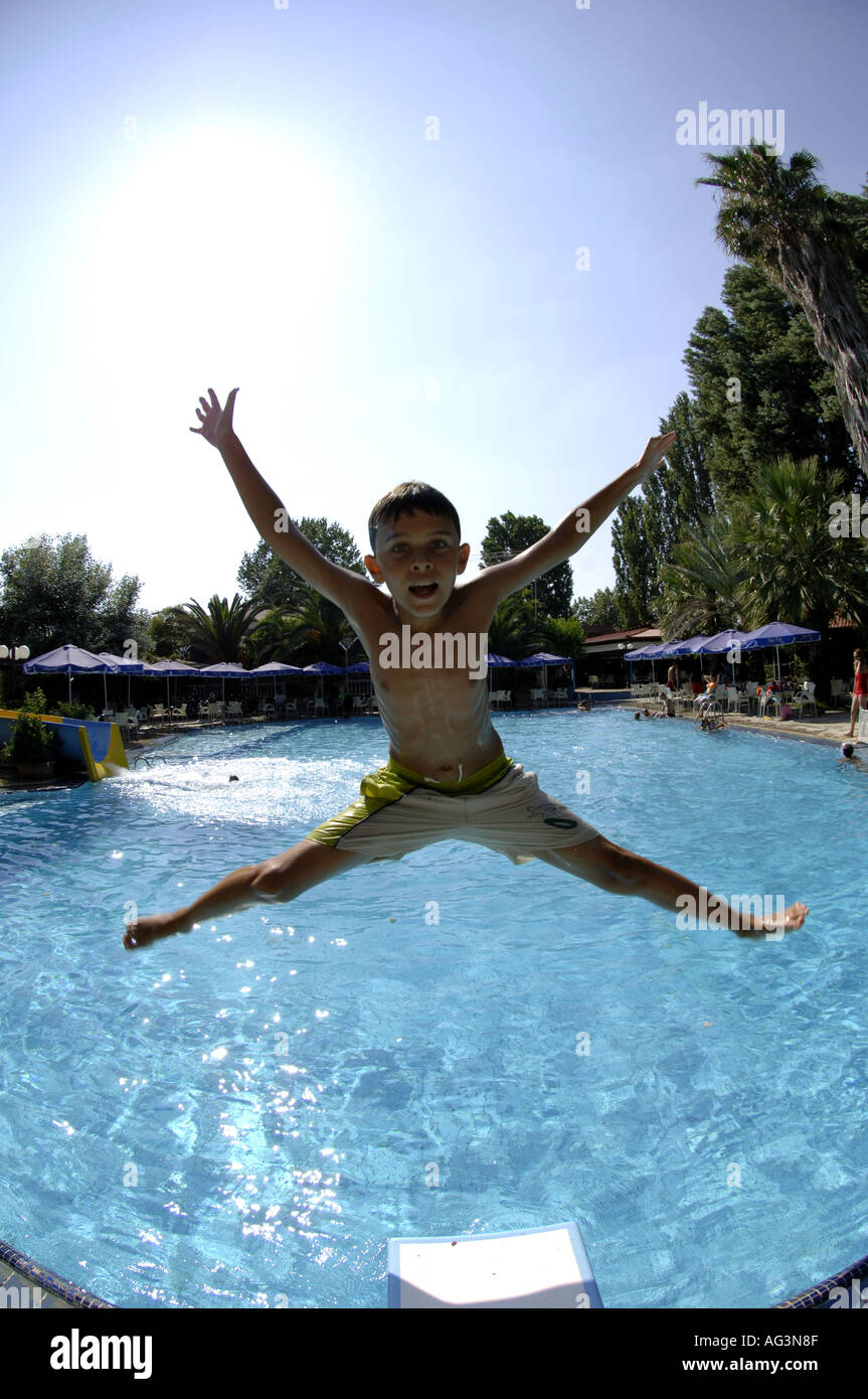 boy leaps into swimming pool Stock Photo - Alamy