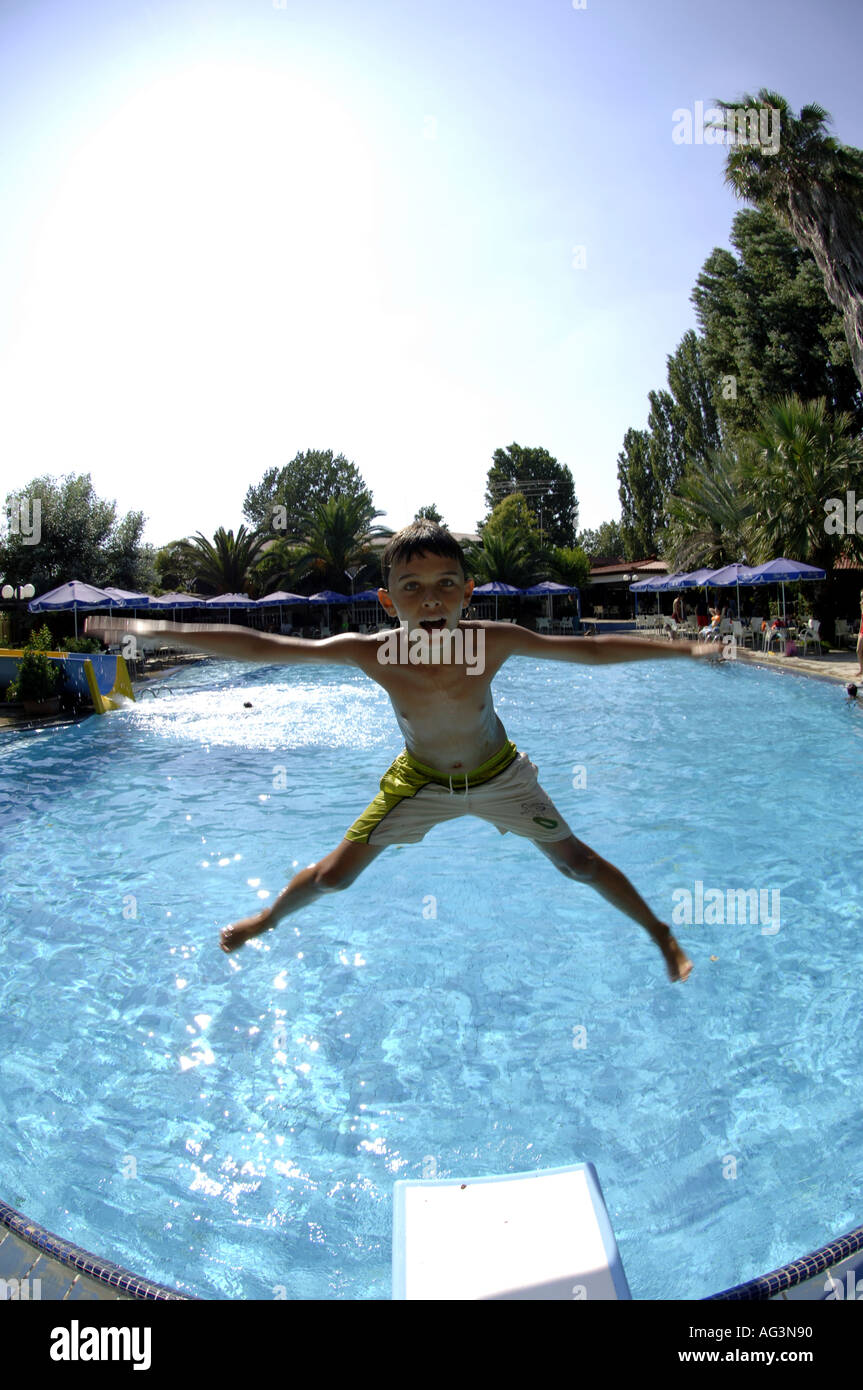 boy leaps into swimming pool Stock Photo - Alamy