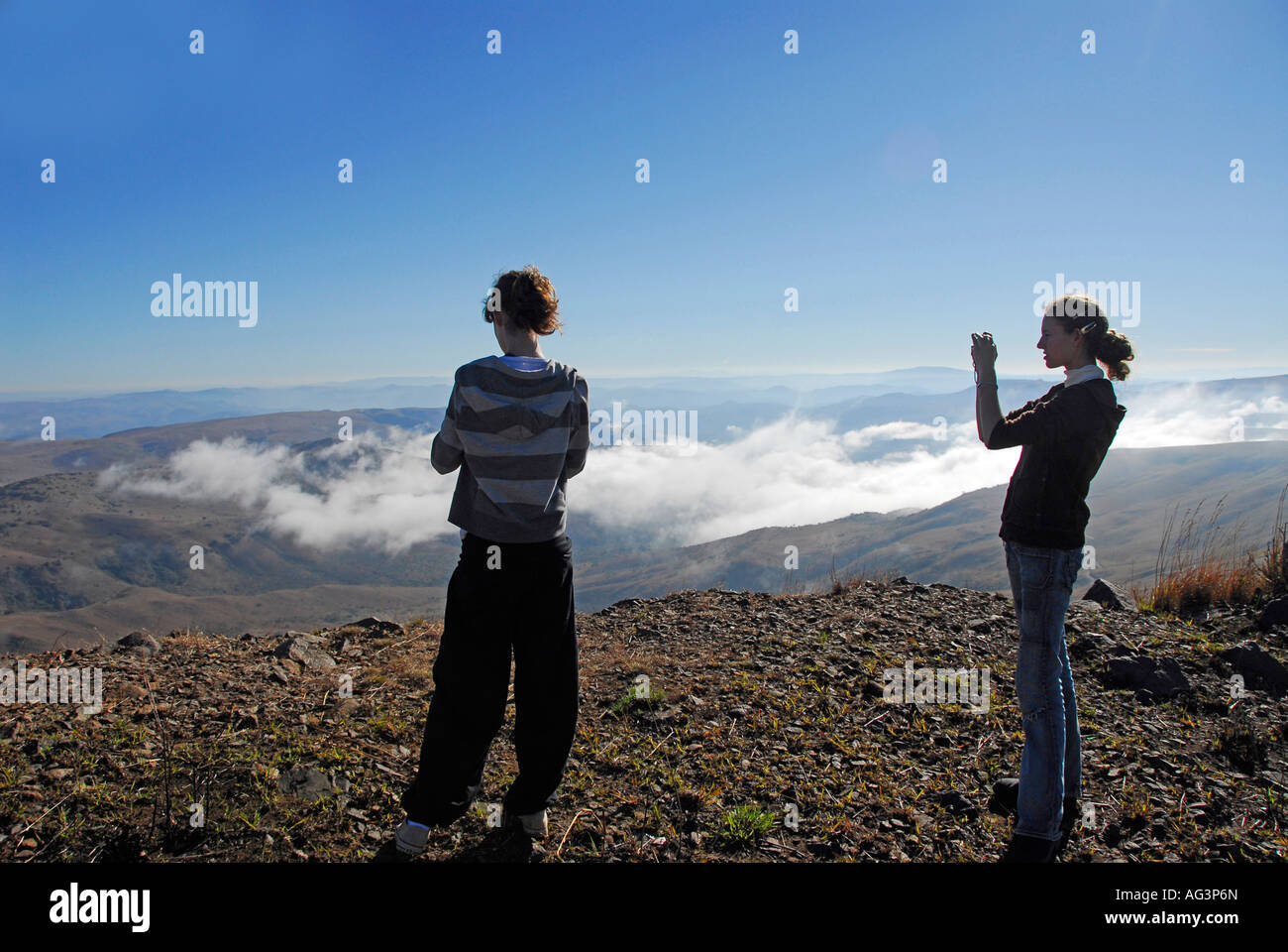Girls photographing the Natal Drakensberg near Louwsburg. The Itala ...