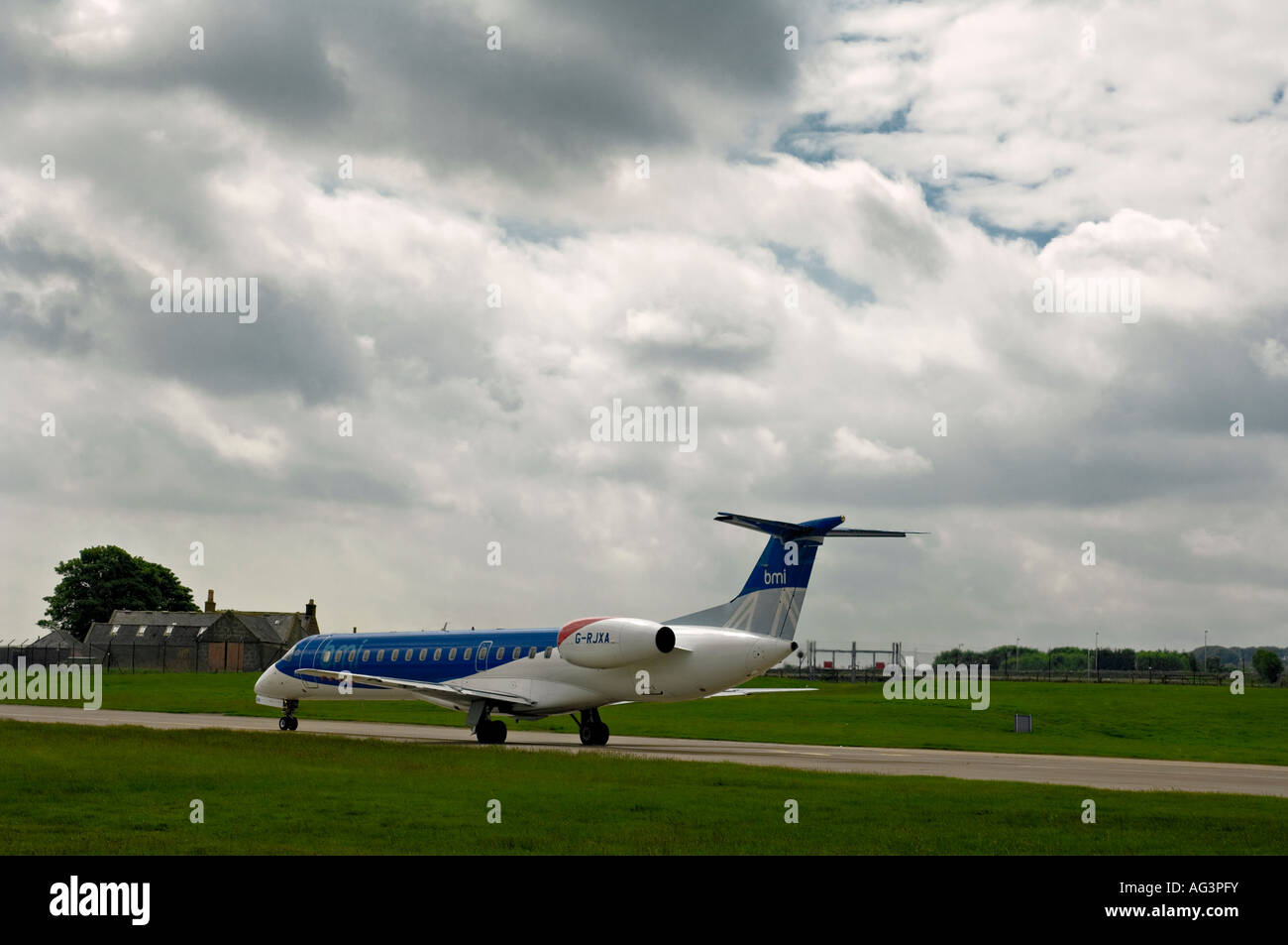 Aircraft taxiing on airport runway Stock Photo - Alamy