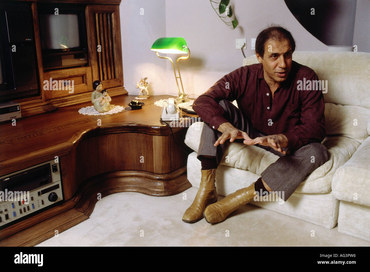 Celentano, Adriano, * 6.1.1938, Italian actor, full length, sitting on ...