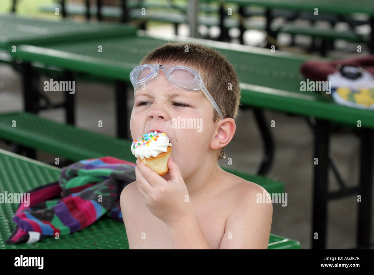 Young boy eating cupcake Stock Photo - Alamy