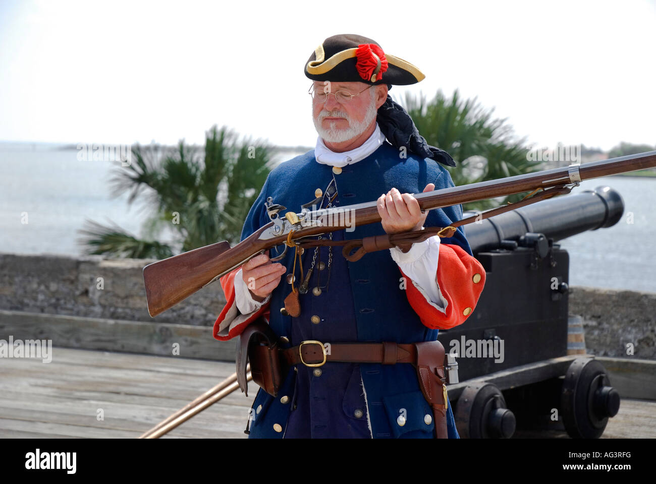 Reenactor prepares to fire flintlock rifle, St. Augustine, Florida ...