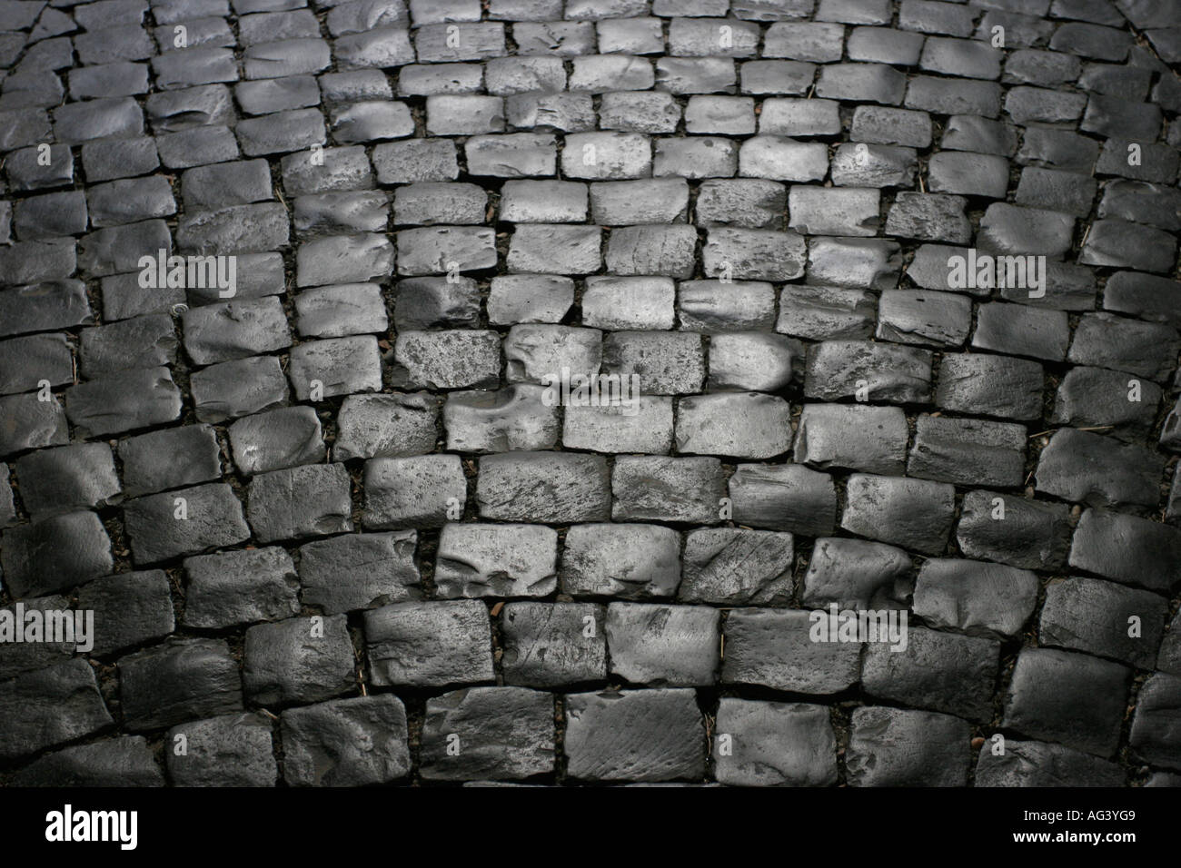 Glistening grey square cobblestone road Stock Photo - Alamy