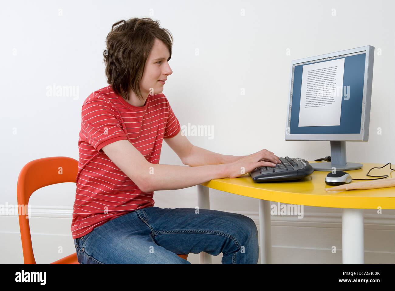 Teenage boy using personal computer Stock Photo - Alamy