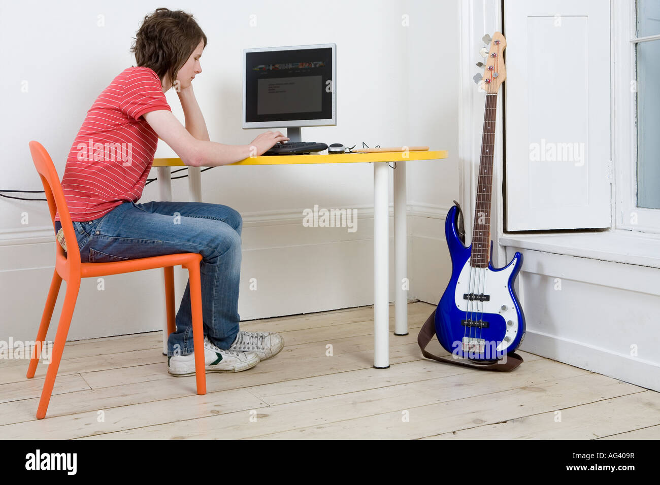 Teenage boy using personal computer Stock Photo - Alamy