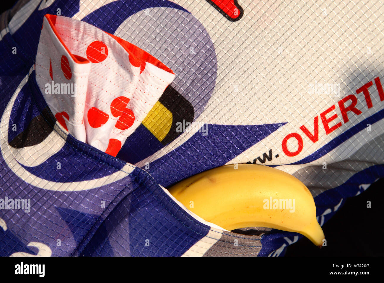 Cycling rider with food snack banana and sun cap in his cycle vest back ...