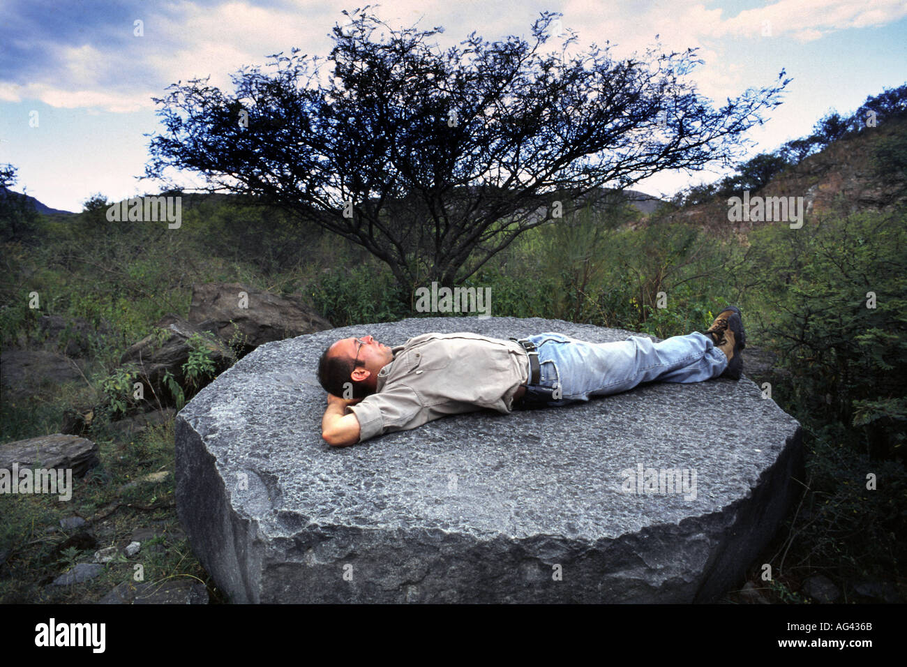 Man sitting on boulder mountain landscape hi-res stock photography and ...