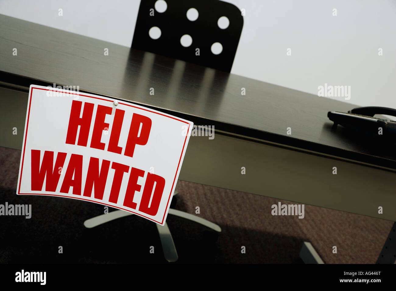 Help wanted sign on a desk Stock Photo - Alamy