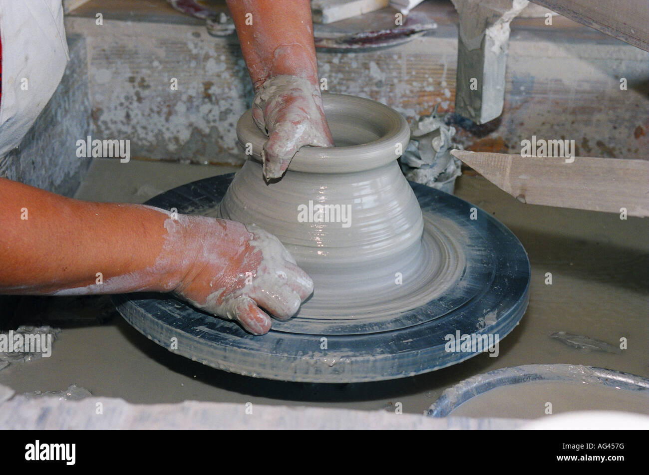 Hands molding wet pottery Stock Photo - Alamy