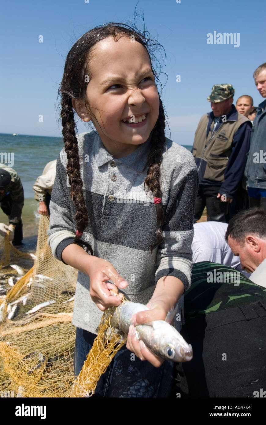 Girl pulling Omul fish from a net Lake Baikal Siberia Russia 2006 Stock ...