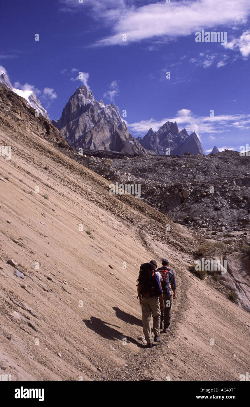Trekkers walking a tight pathas they approach the Baltor Glacier and ...