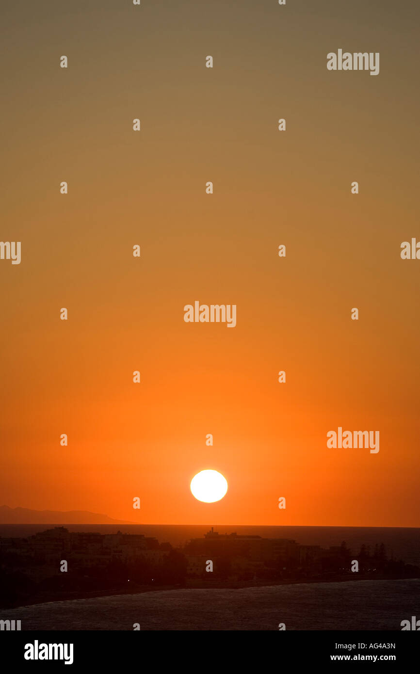 The sun setting over Trianta Bay and the town of Ixia on the Greek ...