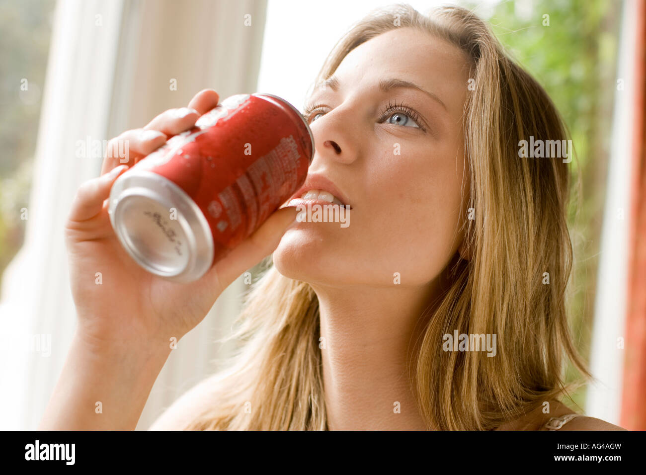 Girl drinking Cola from tin Stock Photo - Alamy