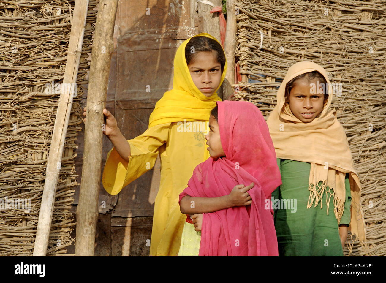 Village Life three girl children wearing dresses yellow red green in ...