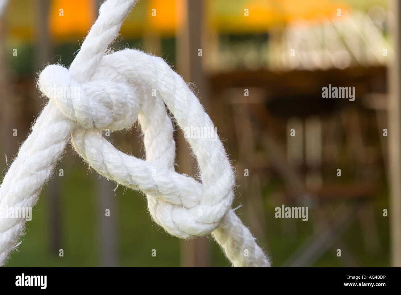 White knotted rope on a blurred colorful background Stock Photo - Alamy