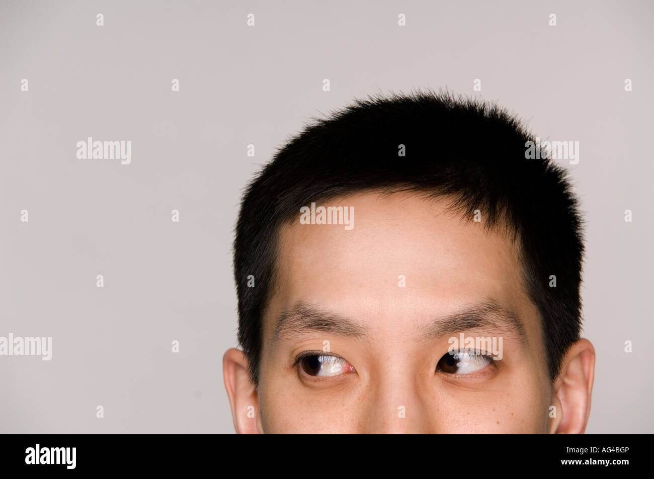 Sneaky Asian man suspiciously peeking Stock Photo - Alamy