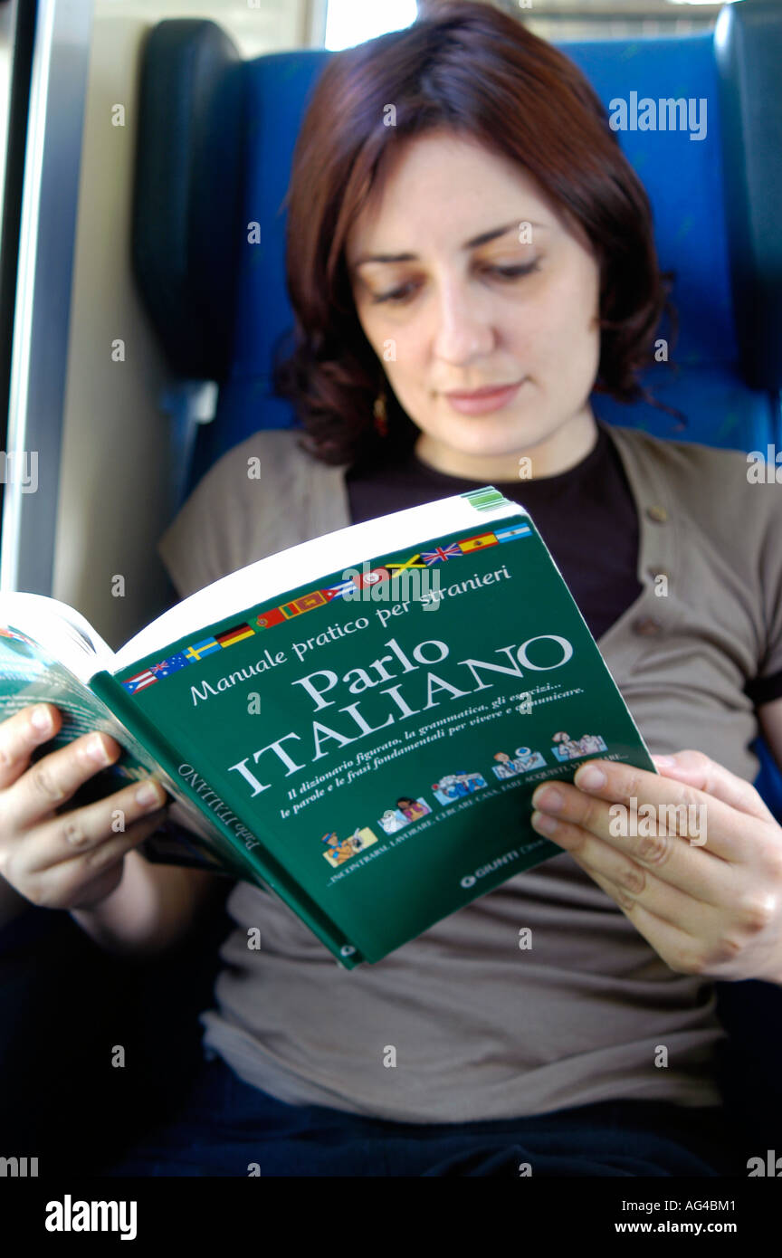 Woman reading an Italian language book Stock Photo - Alamy