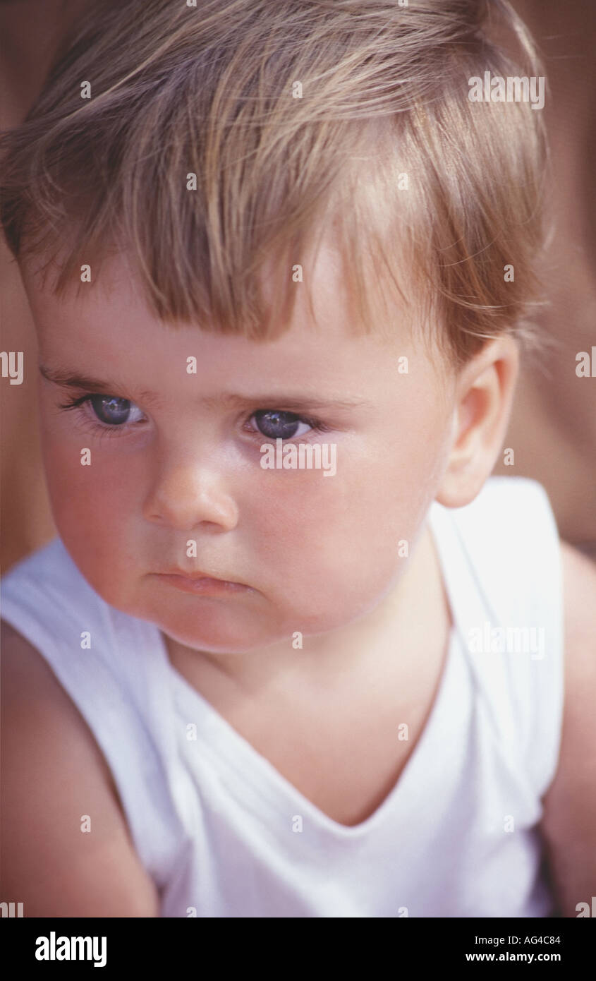 Portrait of a little girl one year old with a very serious look on her ...