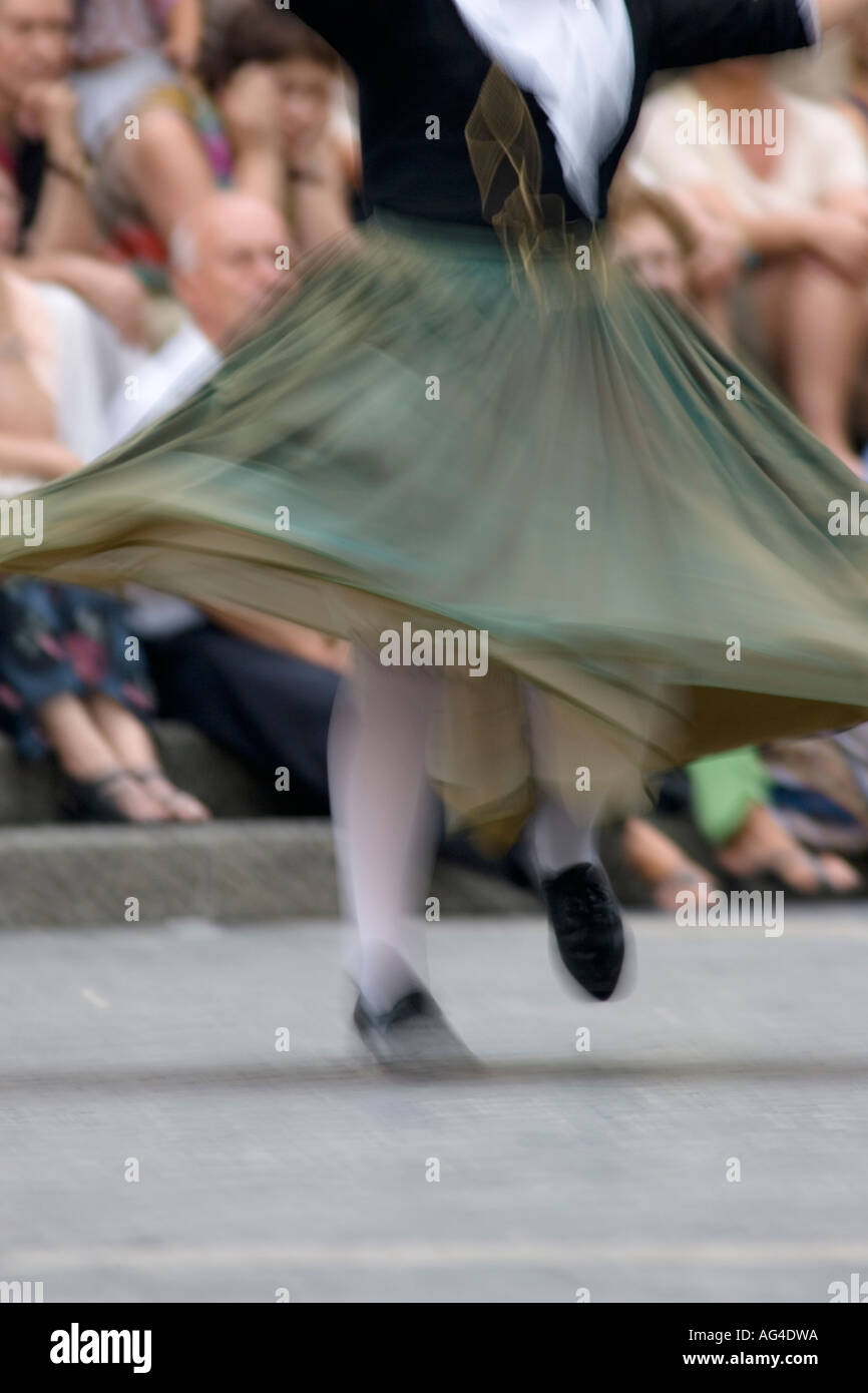 Legs and feet of female Spanish folk dancer wearing deep green dress ...