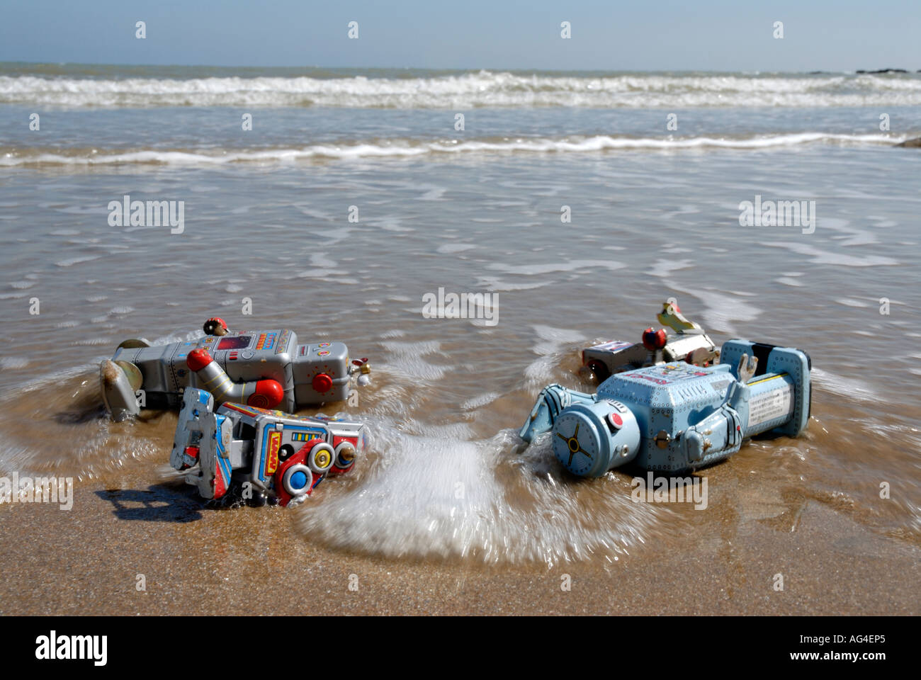 Four robots on the beach Stock Photo - Alamy
