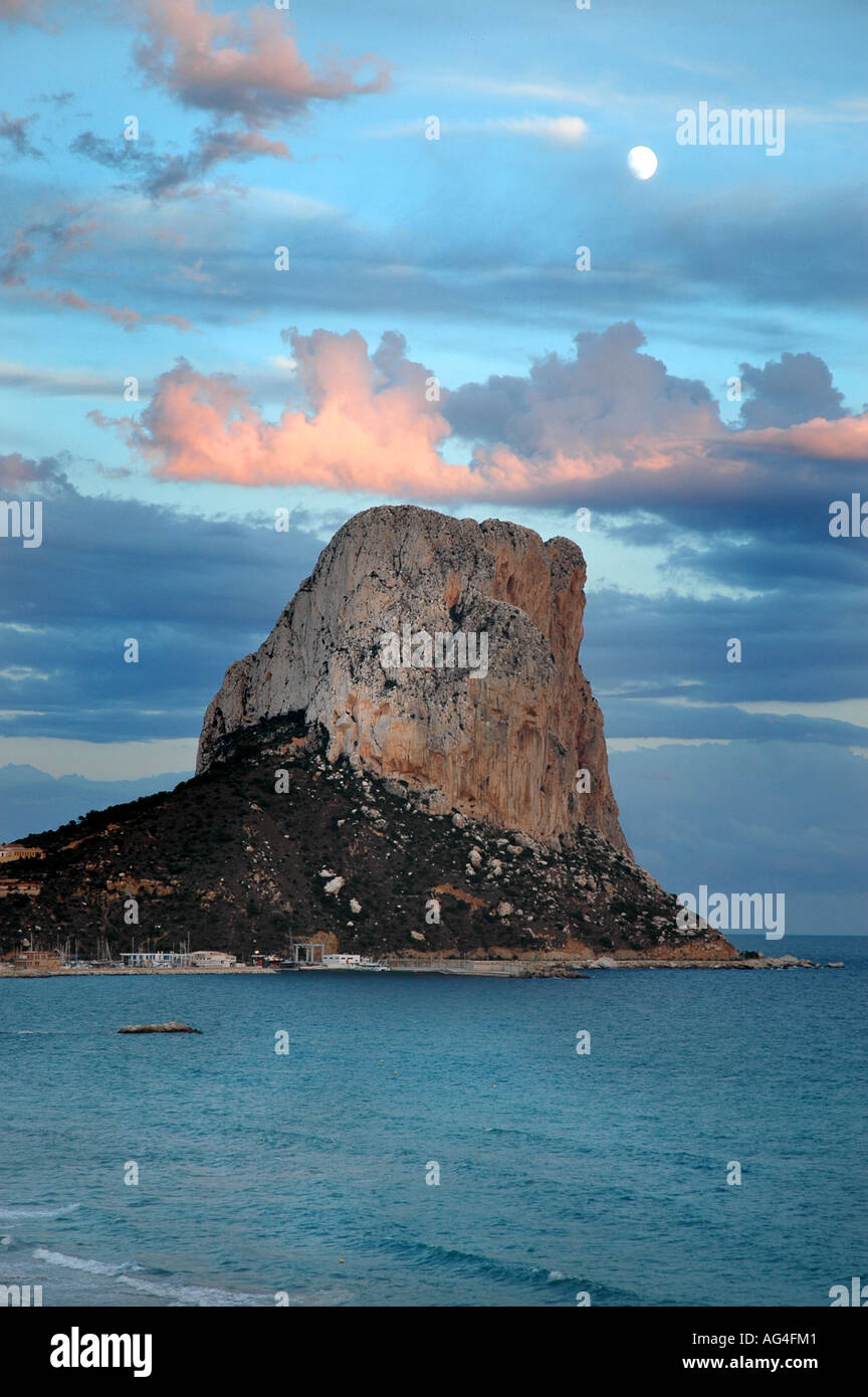 Calpe Rock at sundown with the moon in the background in the resort of ...