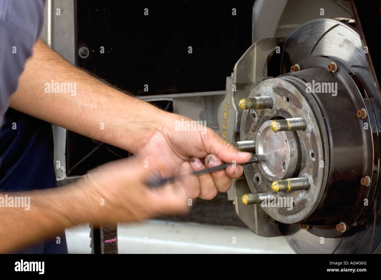 Mechanic Working on Wheel Stock Photo - Alamy