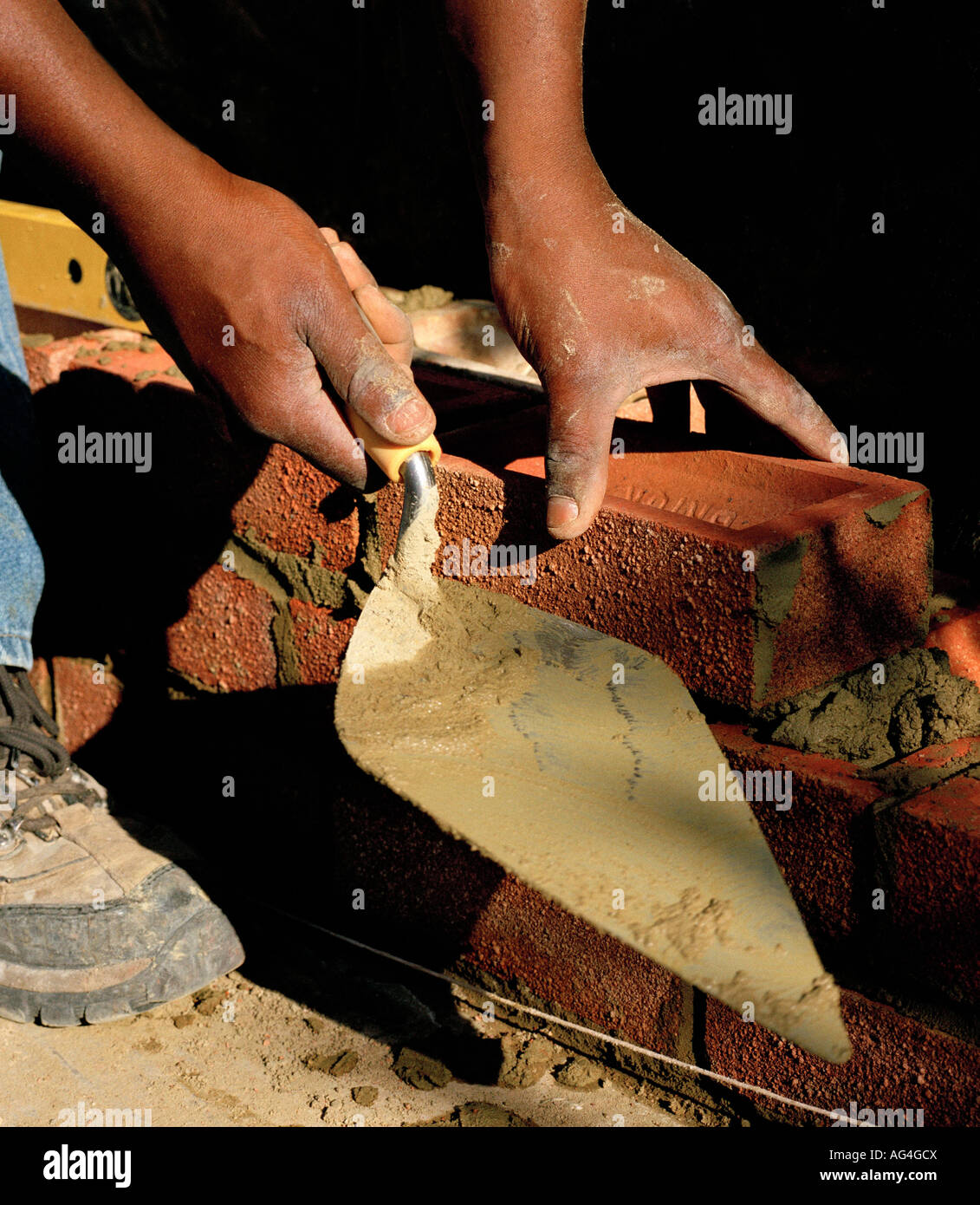 Man building a wall, with a trowel Stock Photo - Alamy