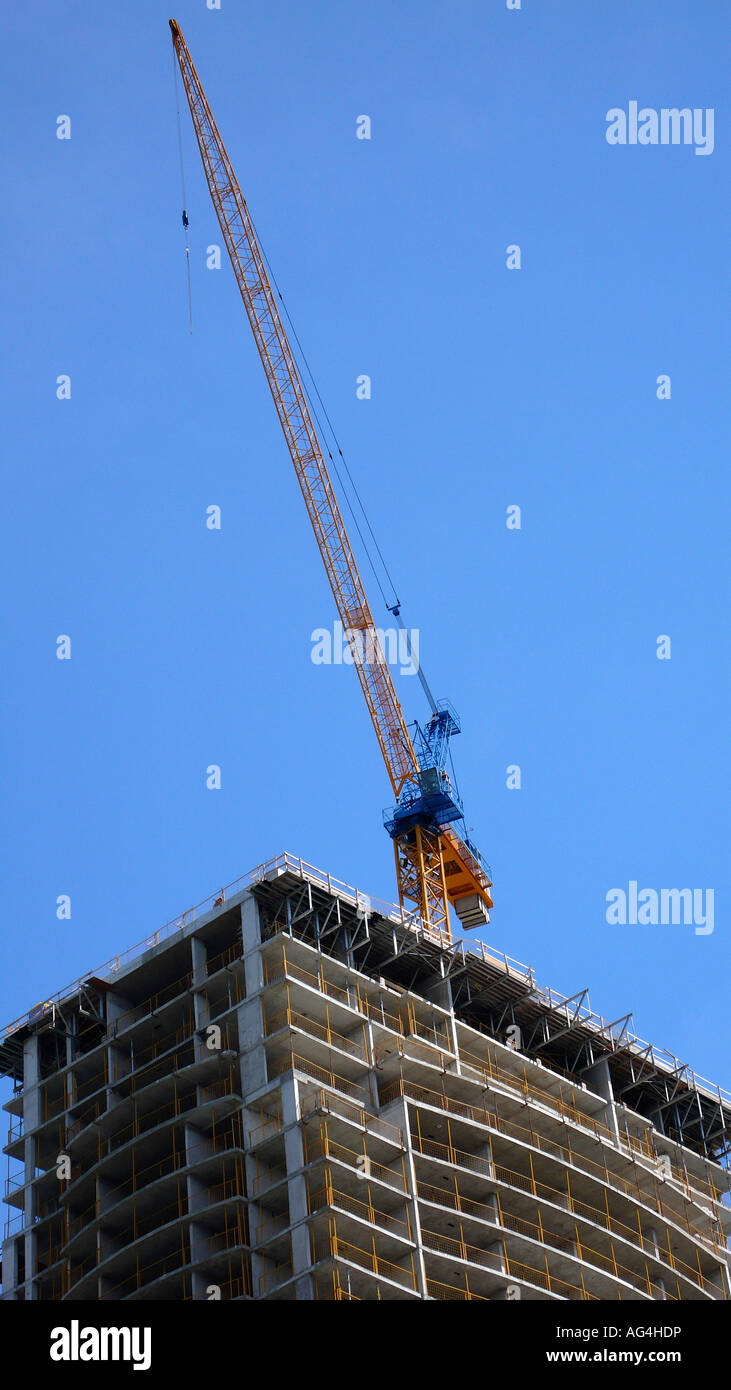 Crane working on partly-constructed building Stock Photo - Alamy