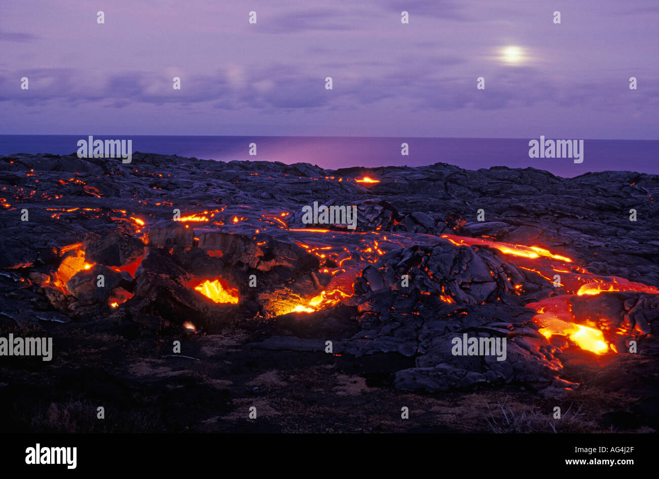 Kilauea lava flow at dusk with a full moon rising at Volcanoes National ...