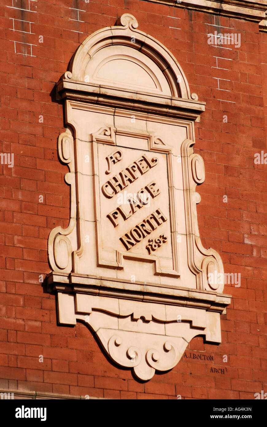 Ornate Victorian stone street sign for Chapel Place North on red brick ...