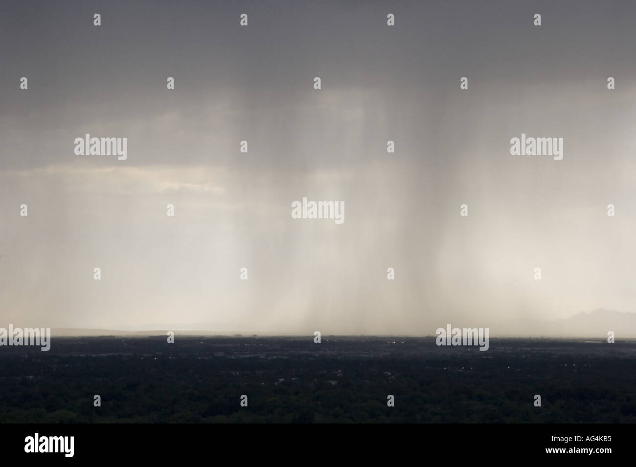 Rain and thunder storm seen approaching from a distance Stock Photo - Alamy