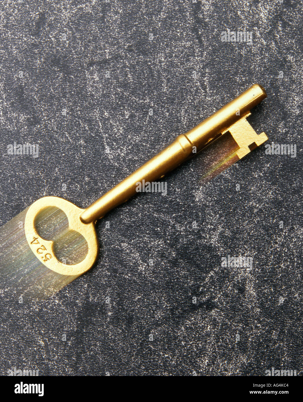 Gold skeleton key on a granite background with a motion trail Stock ...