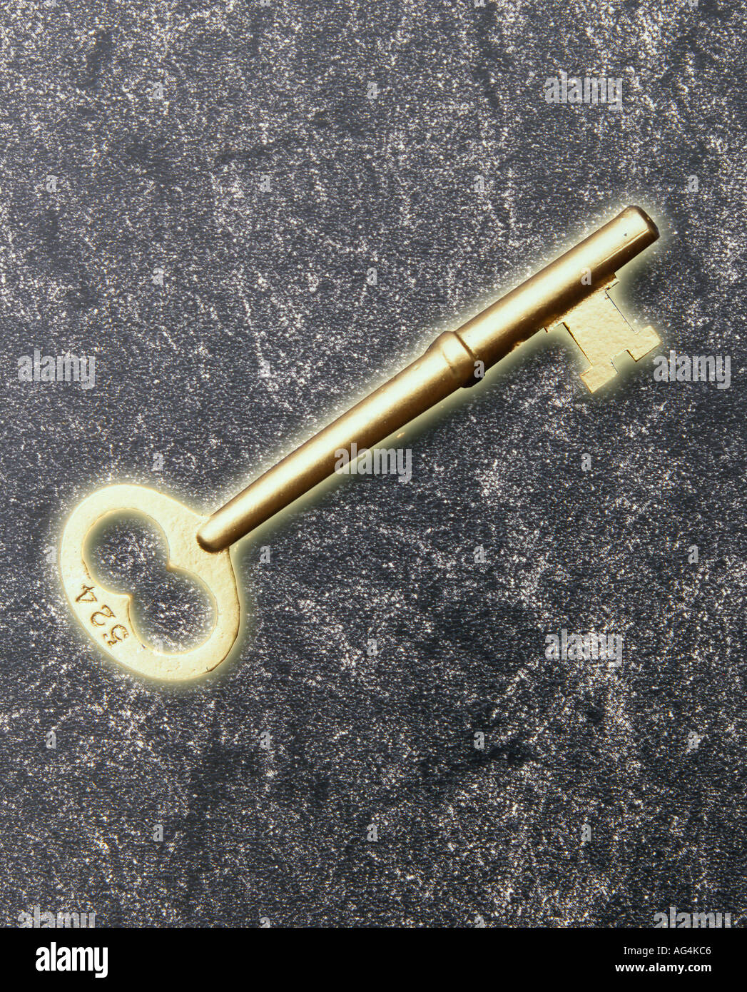 Gold skeleton key on a granite background with a golden glow Stock ...