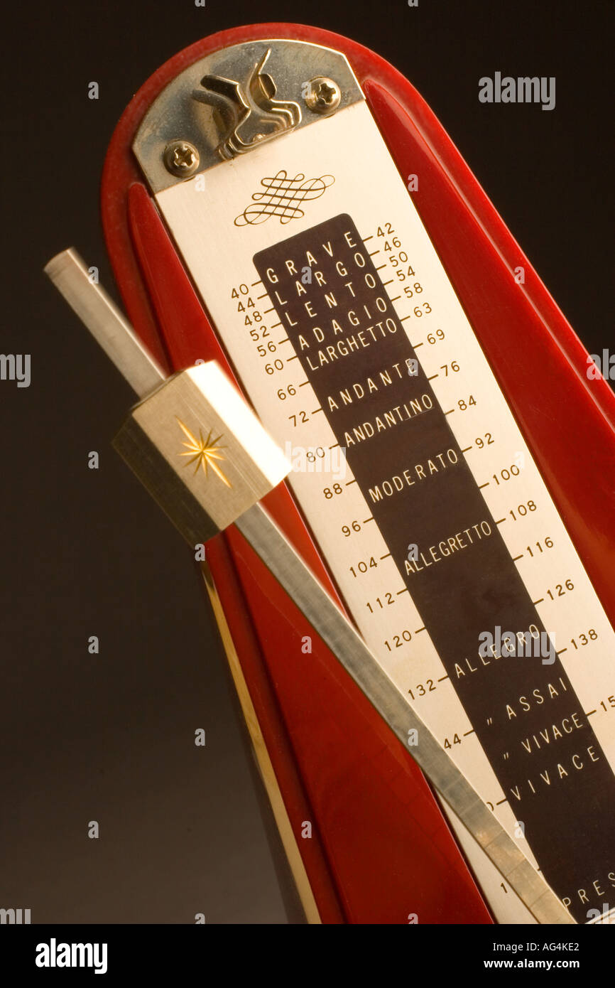 Red metronome with swinging pendulum Stock Photo - Alamy