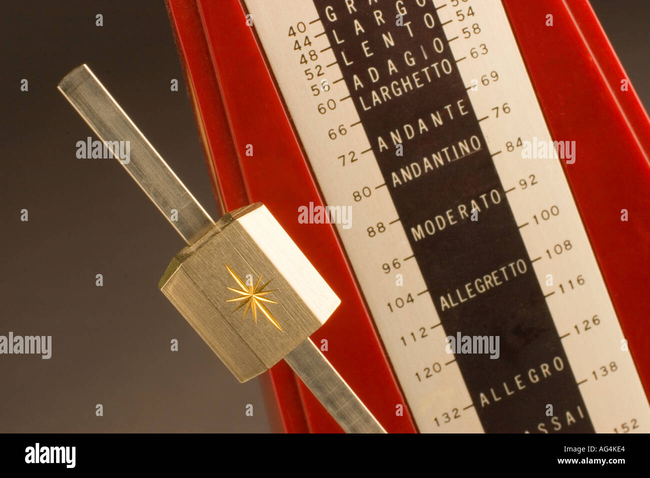 Red metronome with swinging pendulum Stock Photo - Alamy