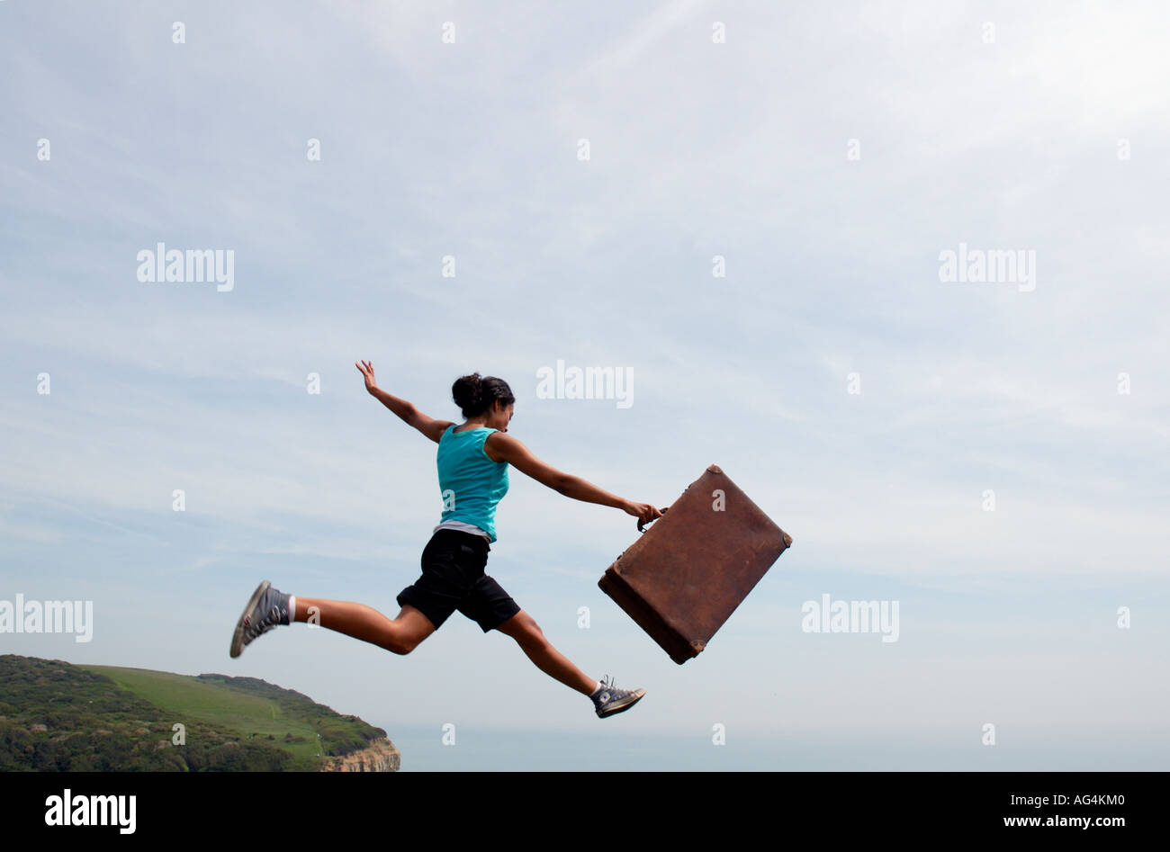 Young girl appearing to leap off a cliff Sarah Klein with suitcase ...
