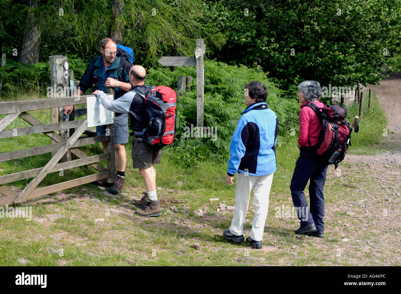 Guided walking group passing through gate on Taff Trail in Brecon ...