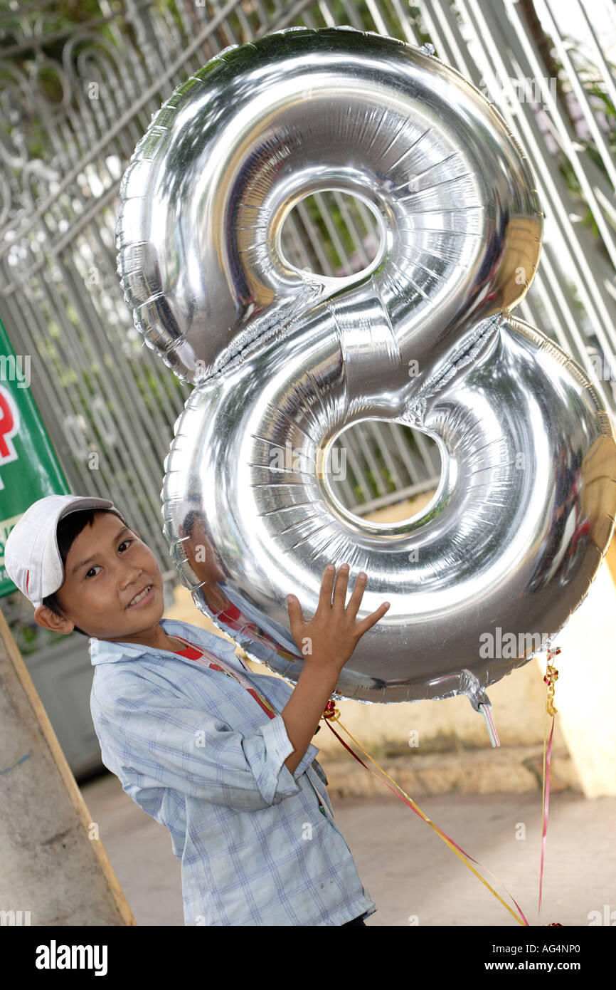 Asian boy with number Eight Stock Photo - Alamy