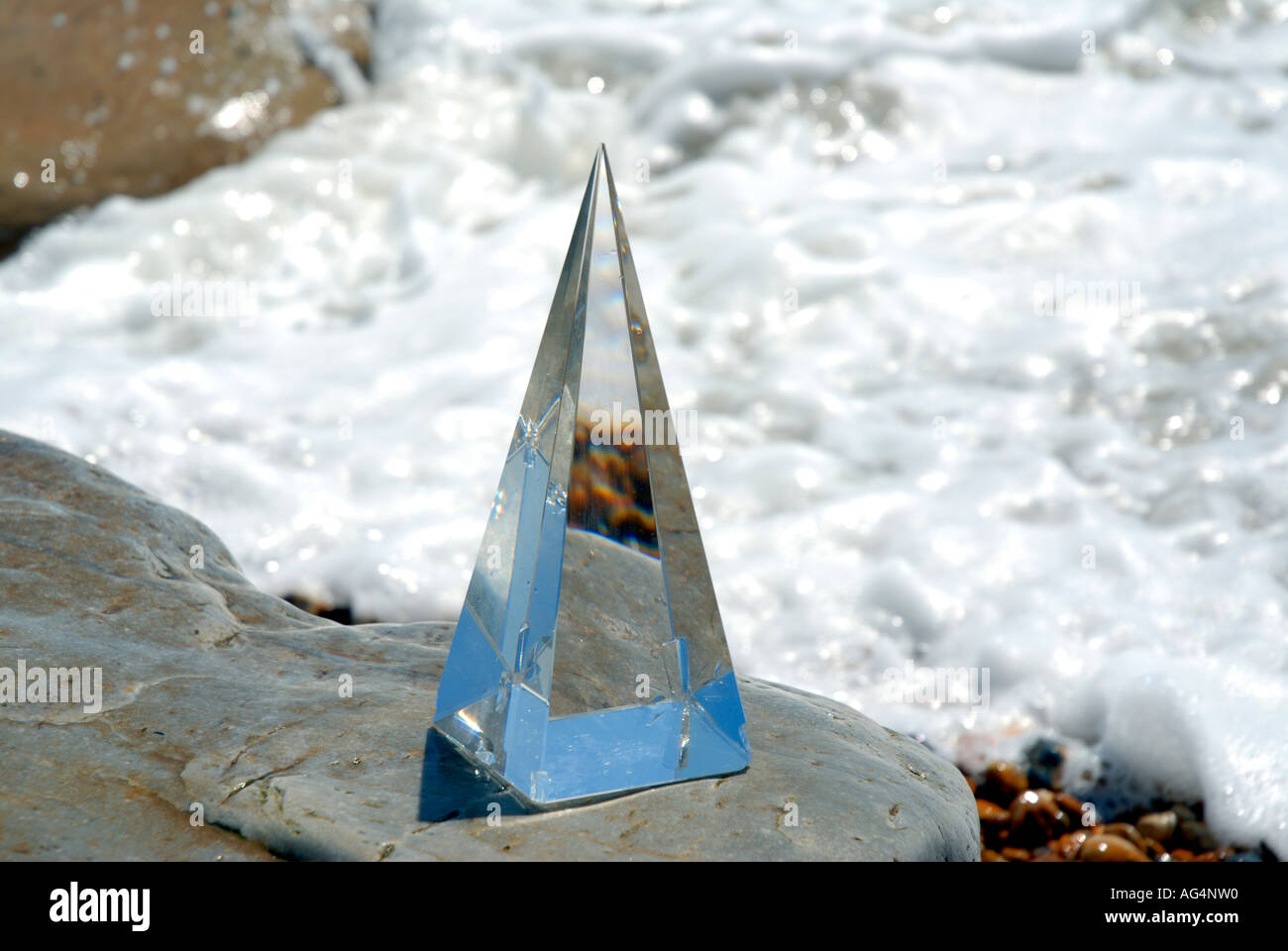 Glass pyramid on seashore beach rock pebbles Stock Photo - Alamy