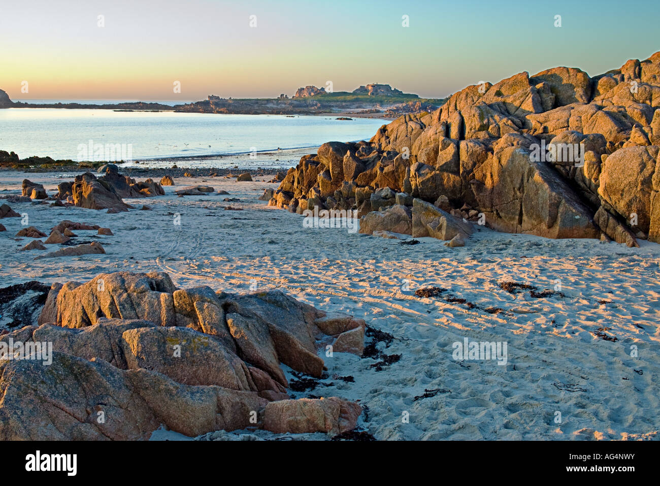Looking over the empty beach at Cobo Bay Stock Photo - Alamy