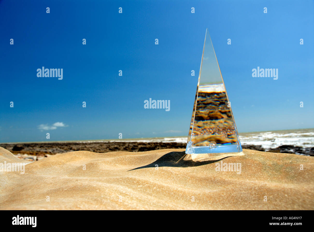 Glass pyramid on seashore beach rock Stock Photo - Alamy