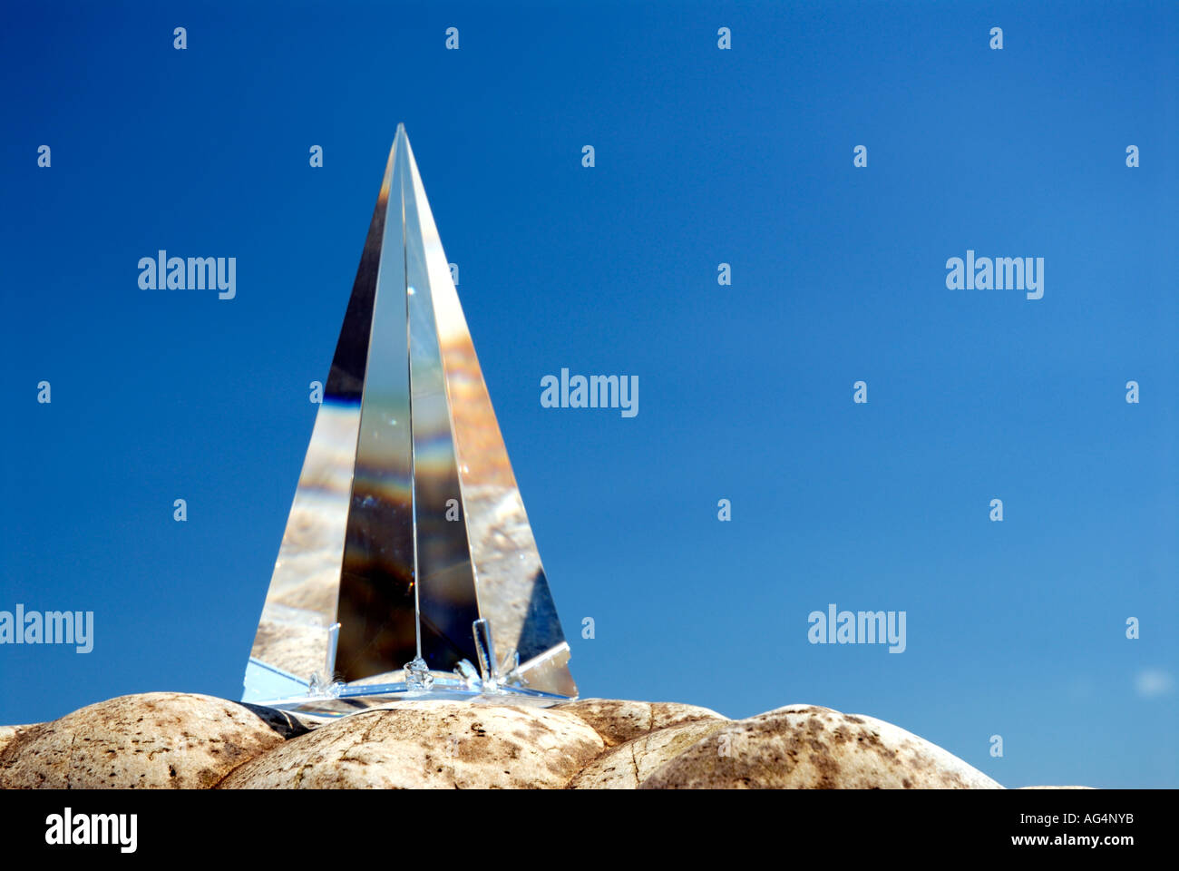 Glass pyramid on rock Stock Photo - Alamy